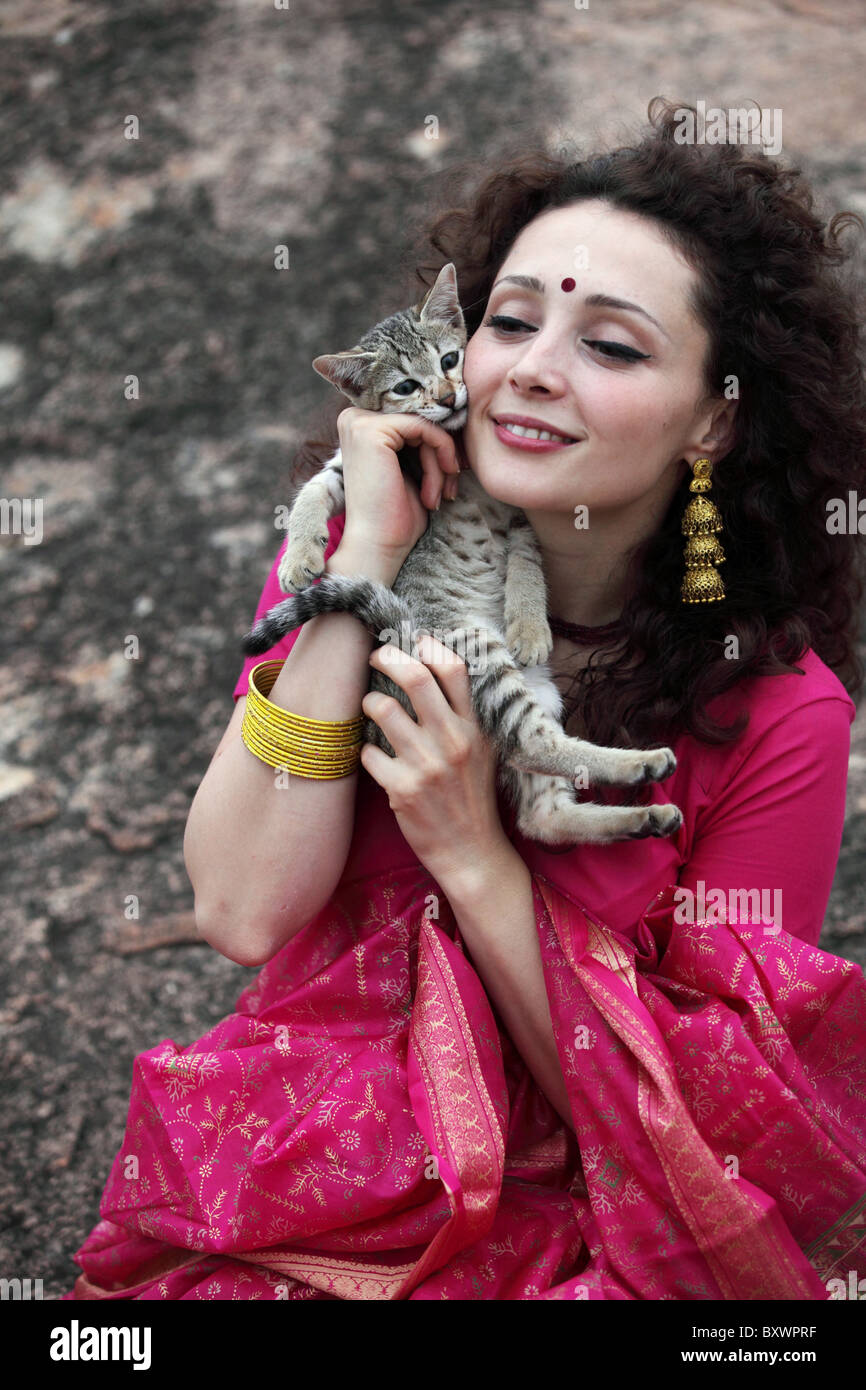 Beautiful lady with kitten wearing a red sari Andhra Pradesh South ...