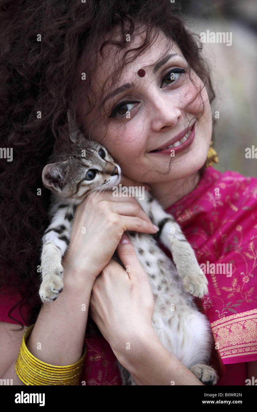 Beautiful lady with kitten wearing a red sari Andhra Pradesh South ...