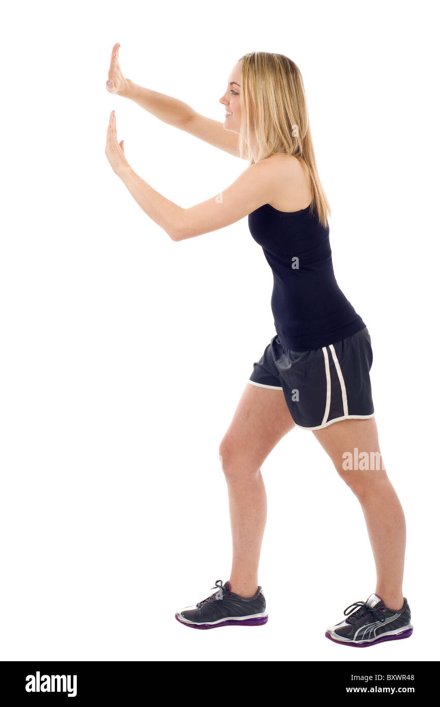 Fitness girl pushing something isolated over white background Stock ...