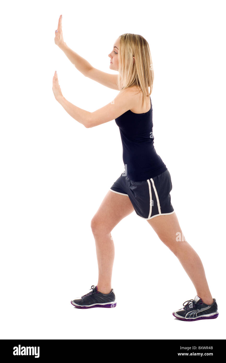 Fitness girl pushing something isolated over white background Stock ...