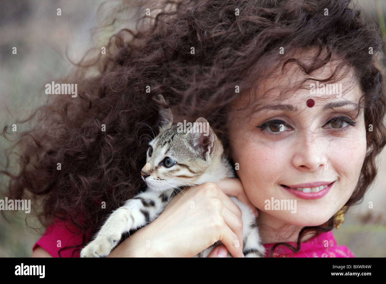 Beautiful lady with kitten wearing a red sari Andhra Pradesh South ...