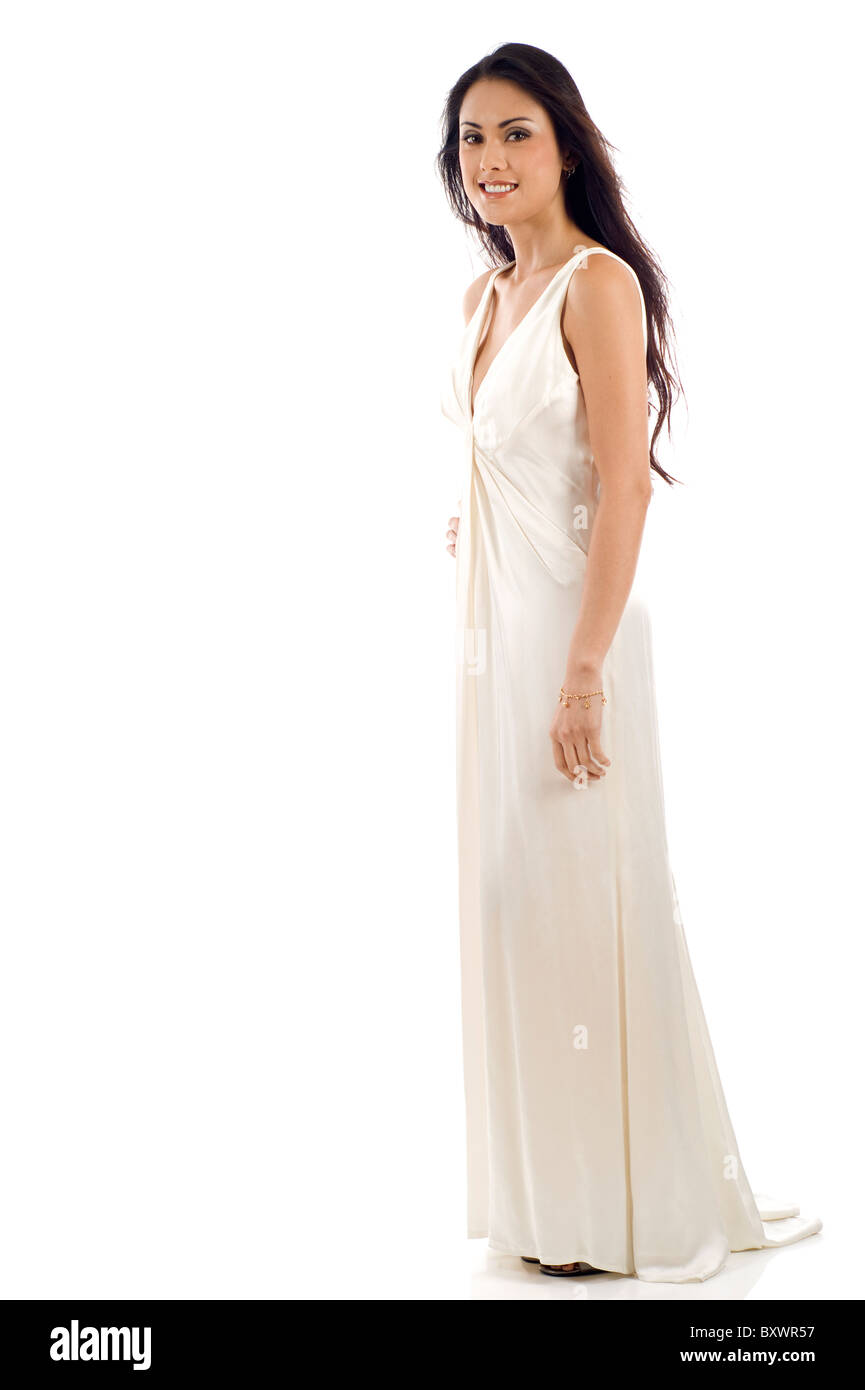 Full length portrait of a confident young Asian woman standing on white ...