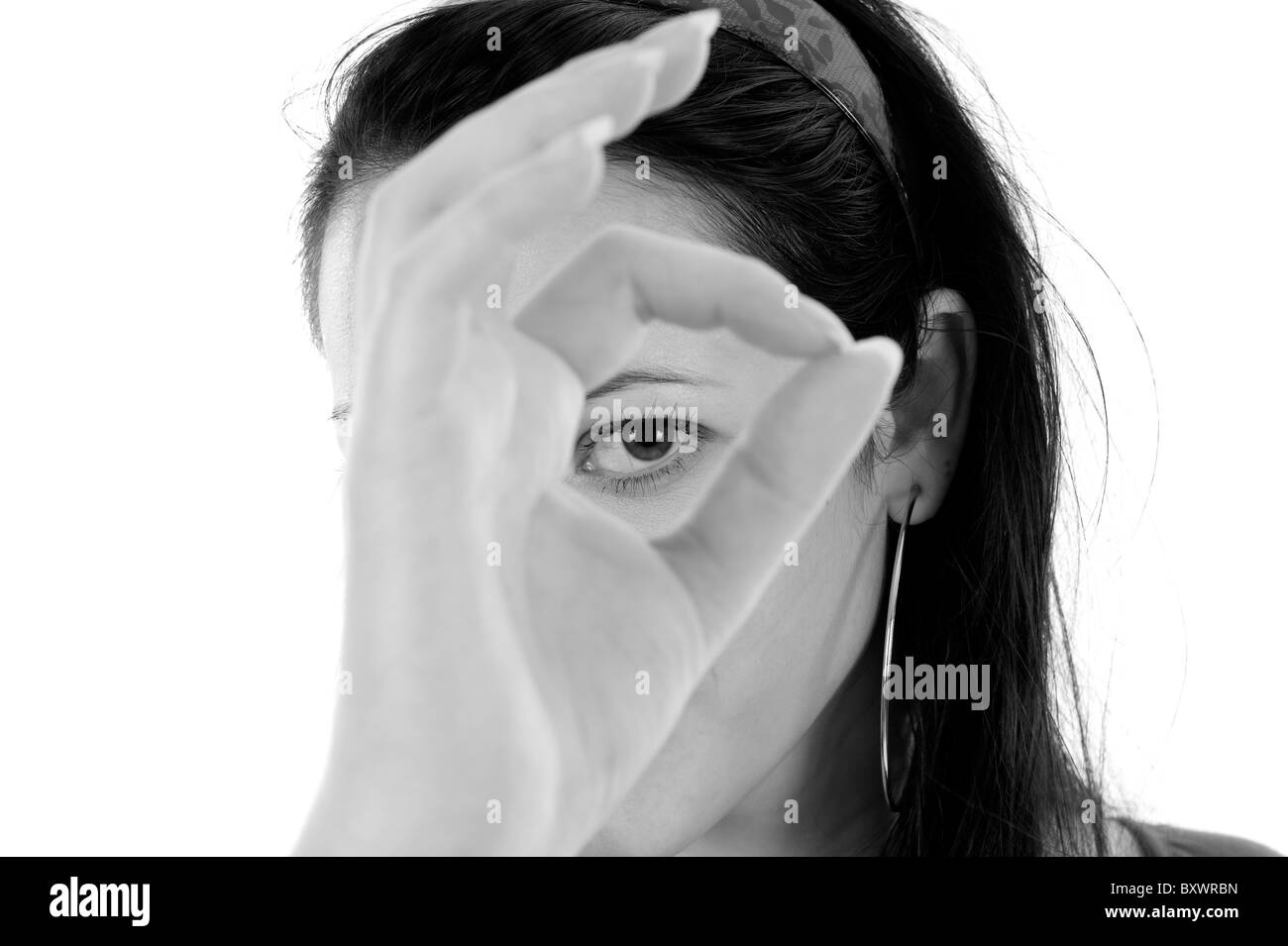 Closeup portrait of a beautiful young female showing okay sign against ...