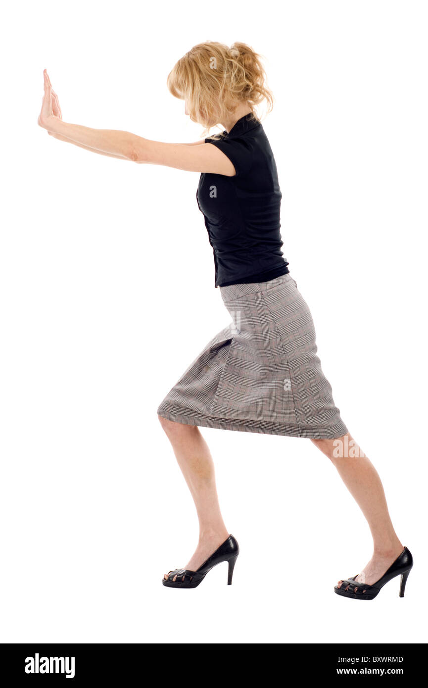 Business woman pushing an imaginary object isolated over a white ...