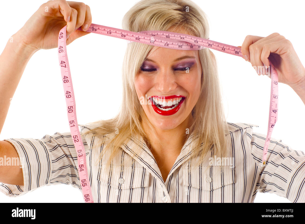 Woman Laughing and Putting Measuring Tape Around her Head Stock Photo ...
