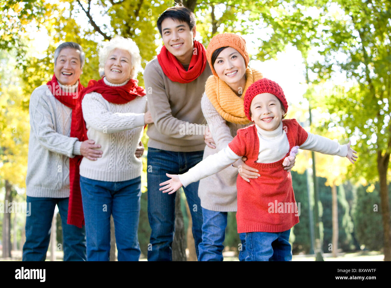 Three Generation Family Playing in a Park in Autumn Stock Photo - Alamy