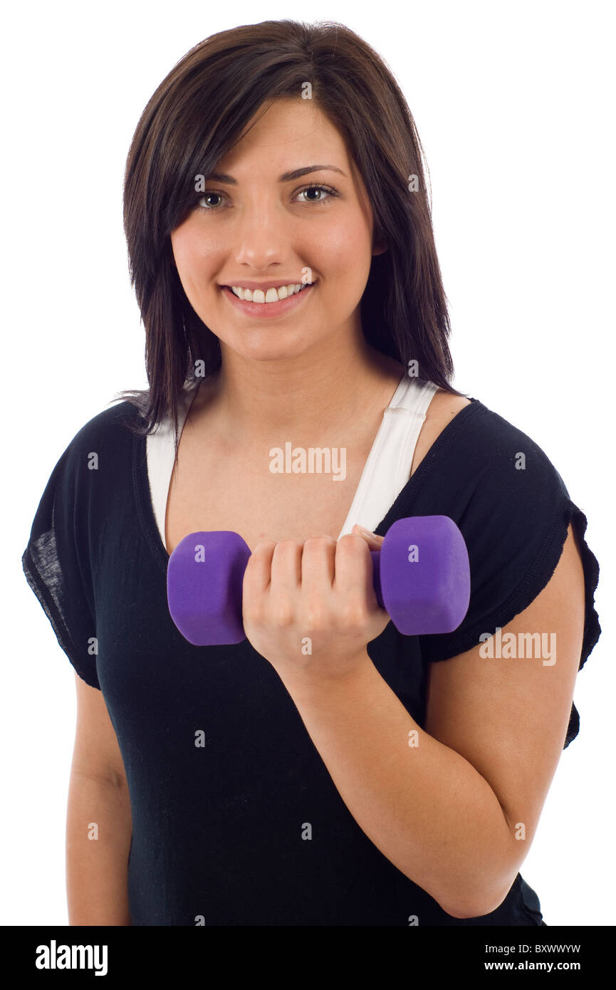 Friendly attractive woman exercising with dumbbell isolated over white ...