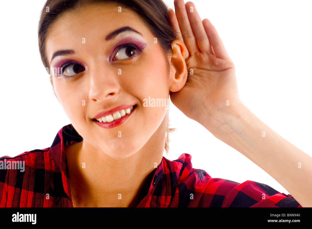 Woman Smiling with Hand to Ear Listening - Isolated over a White ...