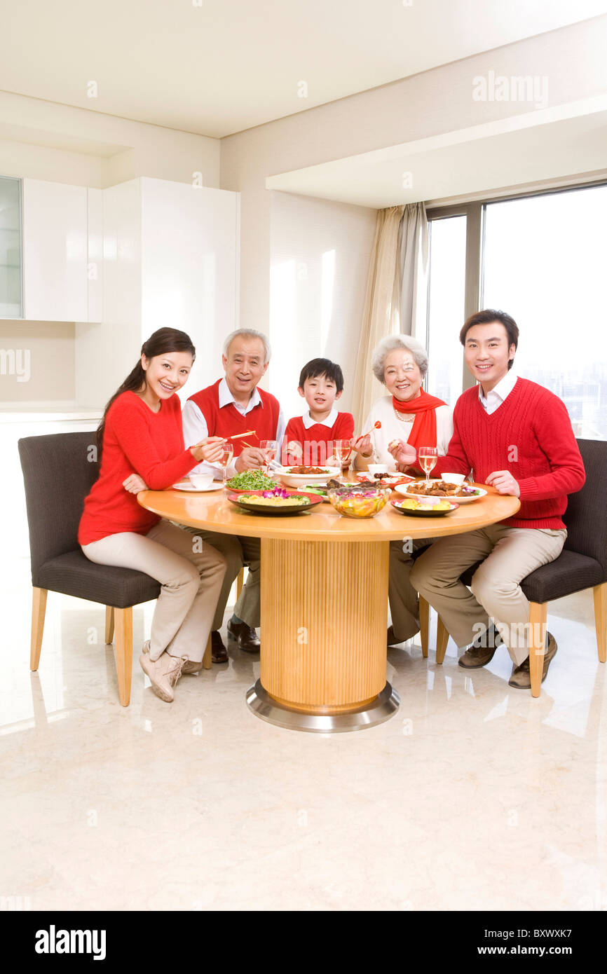 Three generations enjoying a Chinese New Year dinner together Stock ...