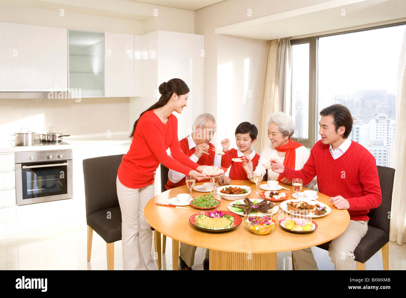 Three generations enjoying a Chinese New Year dinner together Stock ...