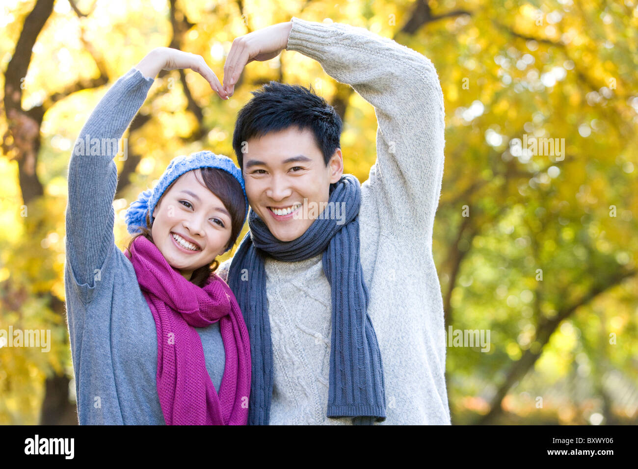 Couple making heart arms hi-res stock photography and images - Alamy