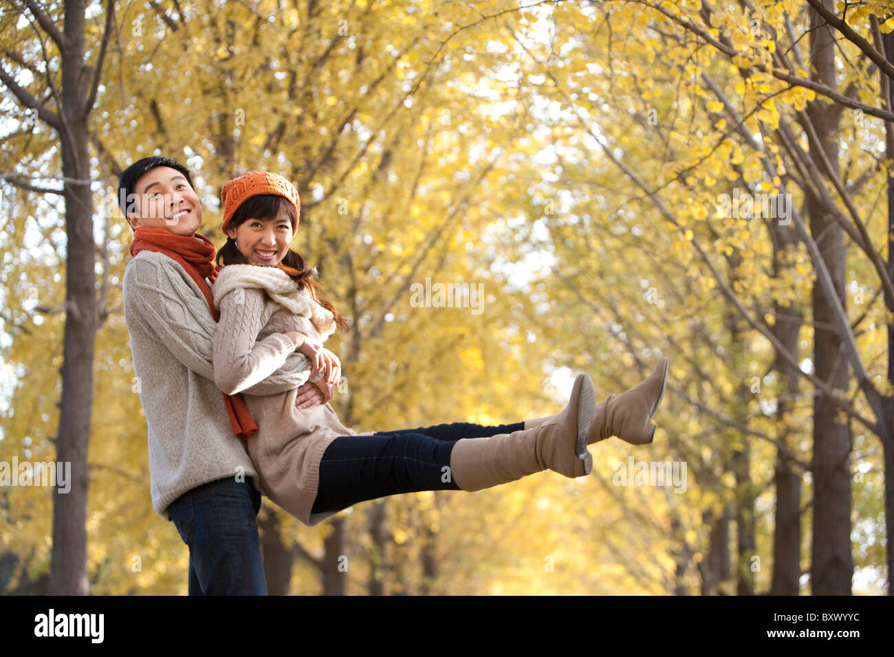 Young Man Playfully Picking Up His Girlfriend Stock Photo - Alamy