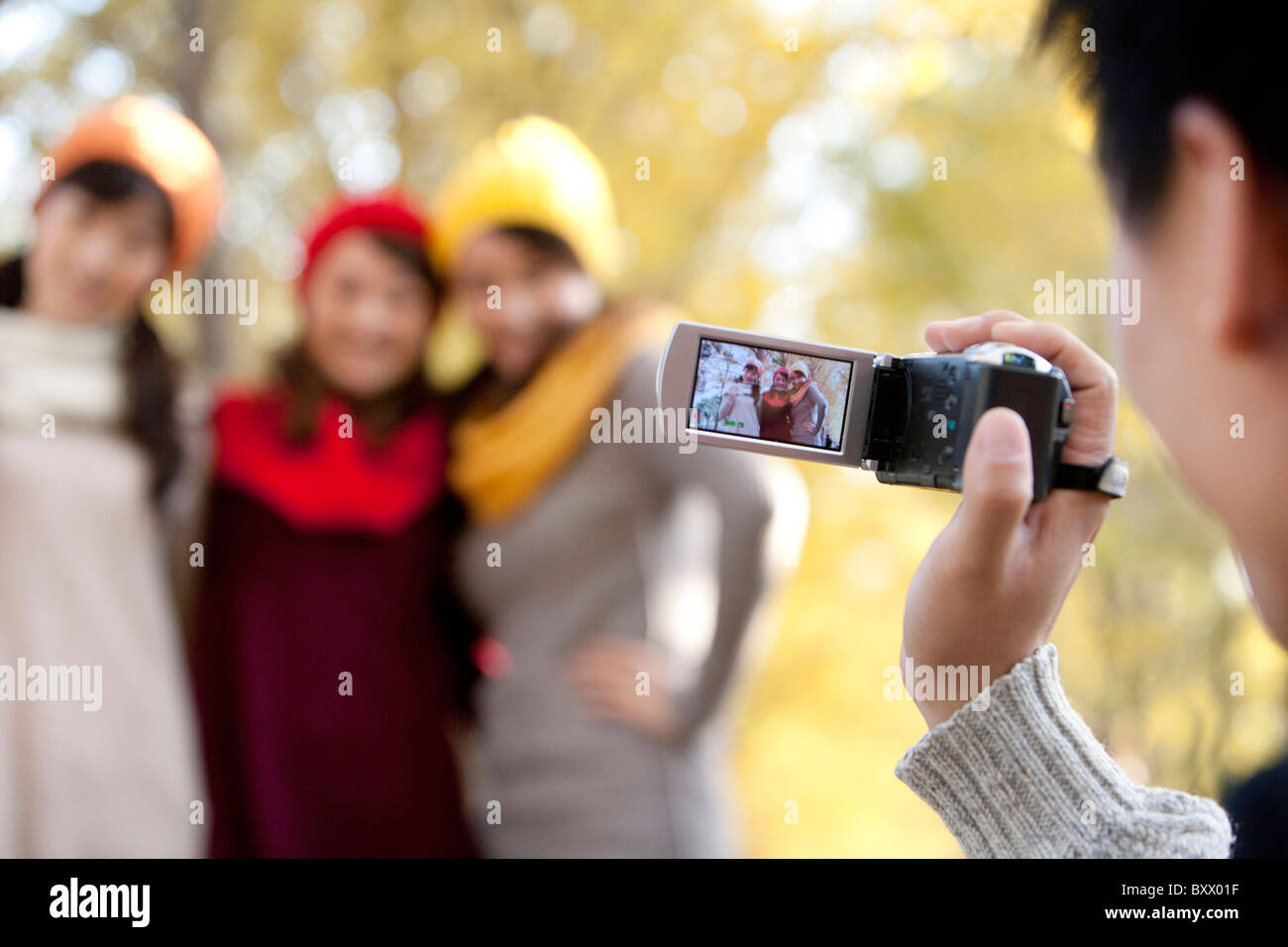 Young Man Filming 3 Friends with a Home Video Camera Stock Photo - Alamy