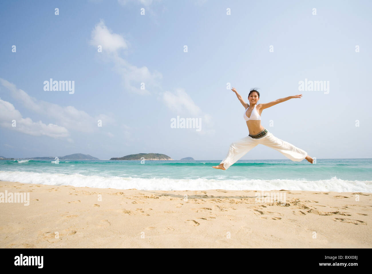 Woman white bikini beach dancing hi-res stock photography and images ...