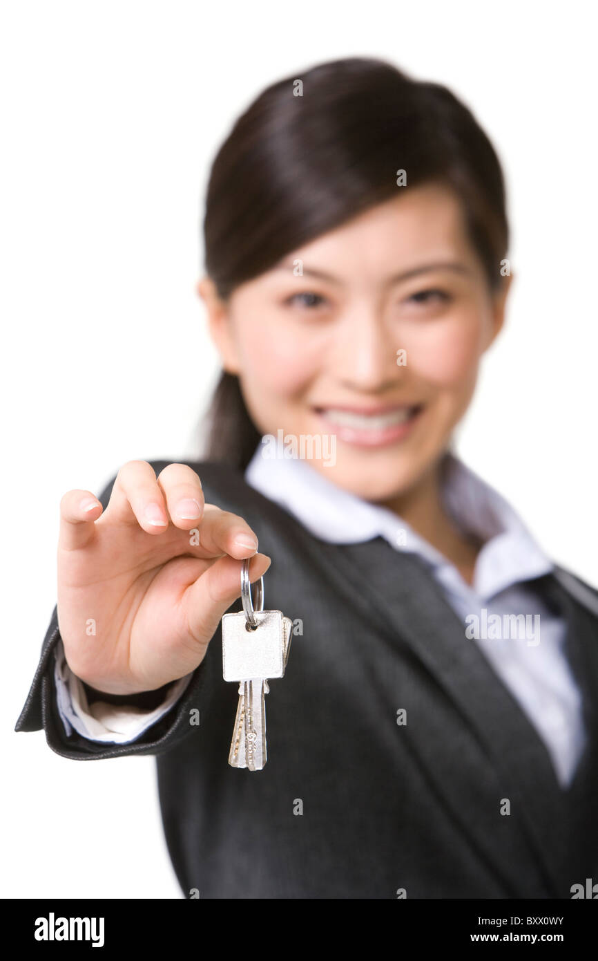 Young woman holding keys Stock Photo - Alamy