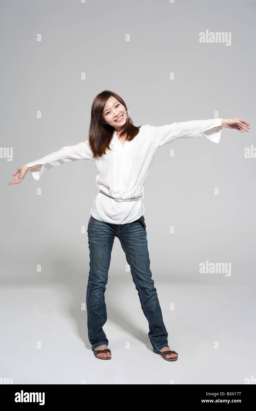 Portrait of Young Woman with Arms Outstretched Stock Photo - Alamy
