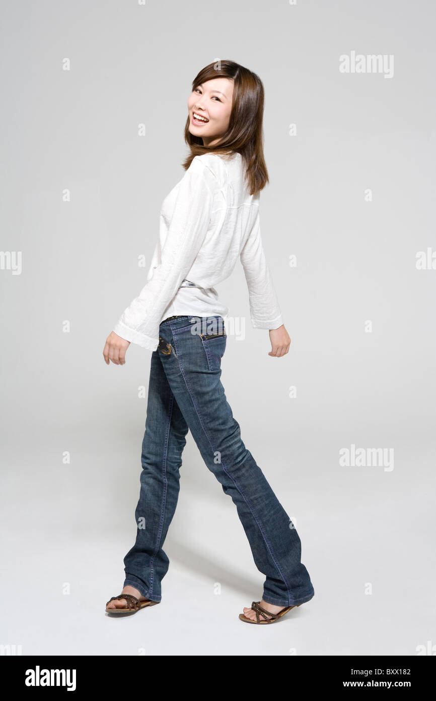 Portrait of Young Woman Looking Over Shoulder Stock Photo - Alamy