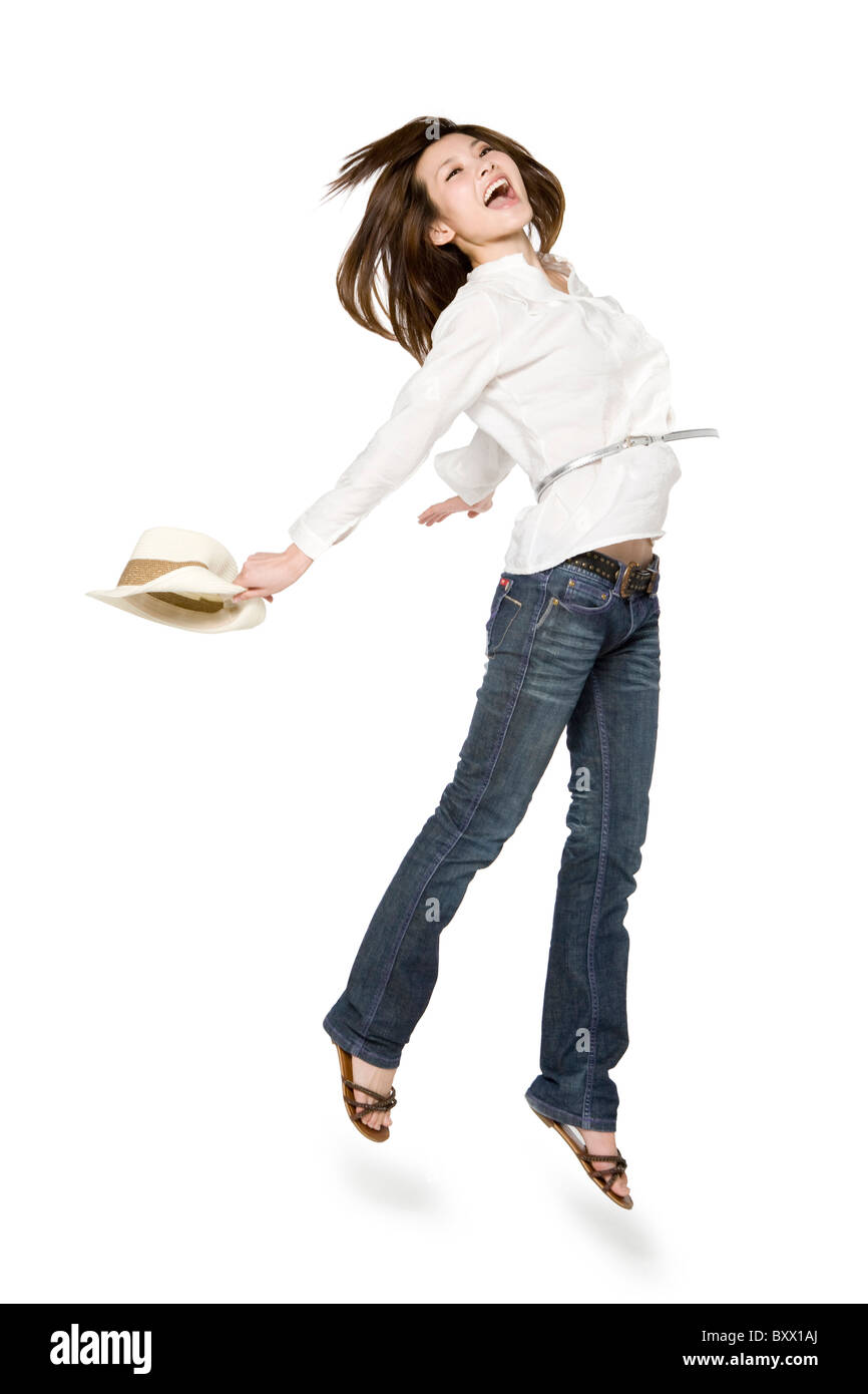 Portrait of Young Woman Jumping Stock Photo - Alamy