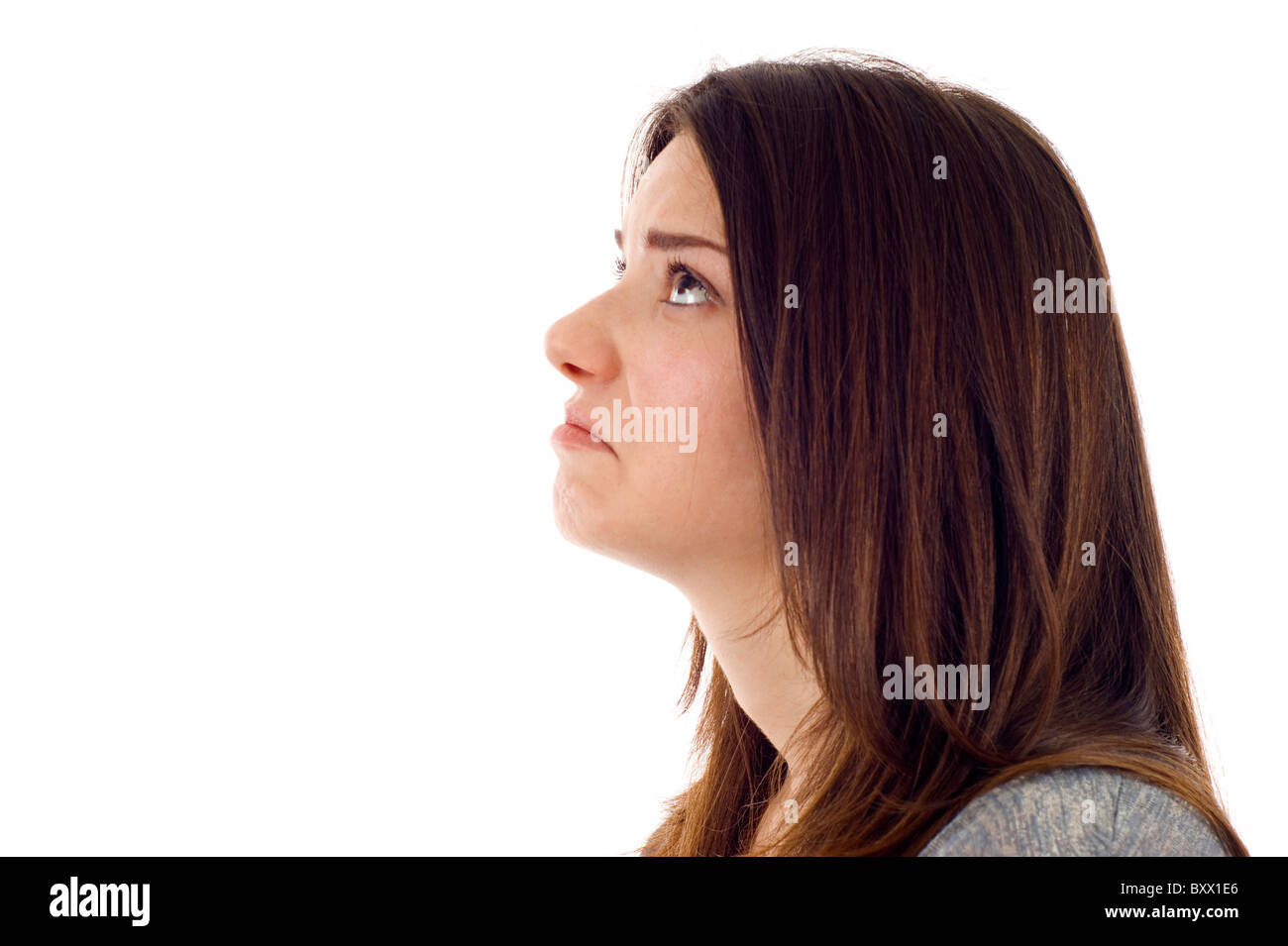 Side view of a sad woman isolated on white, she's looking at the ...