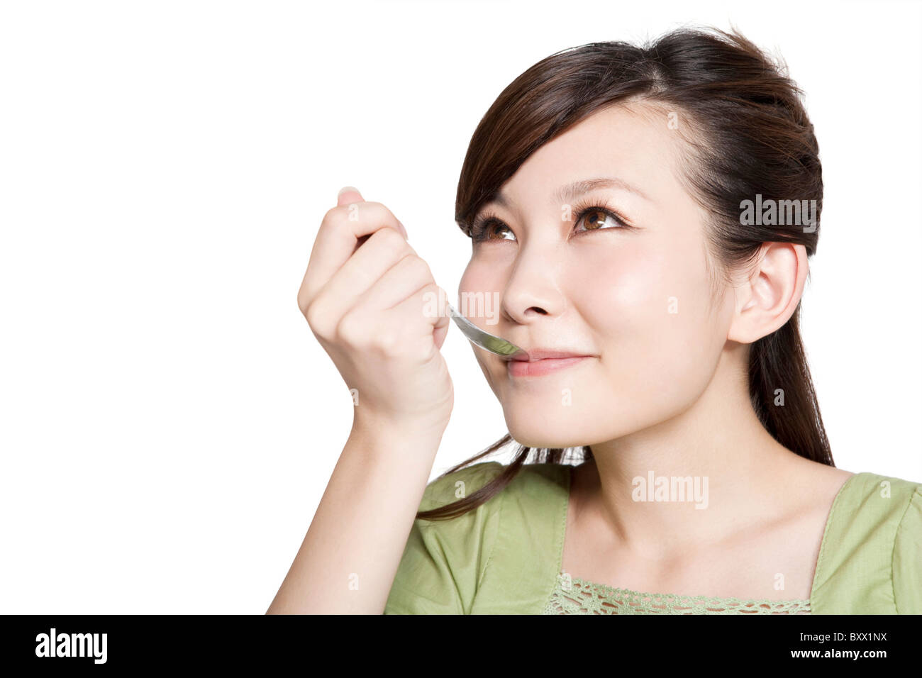 Portrait of Young Woman Eating From Spoon Stock Photo - Alamy