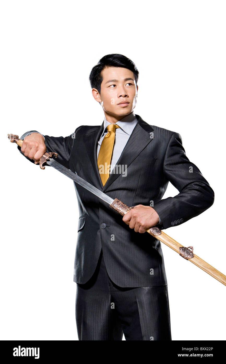 Businessman holding a sword Stock Photo - Alamy