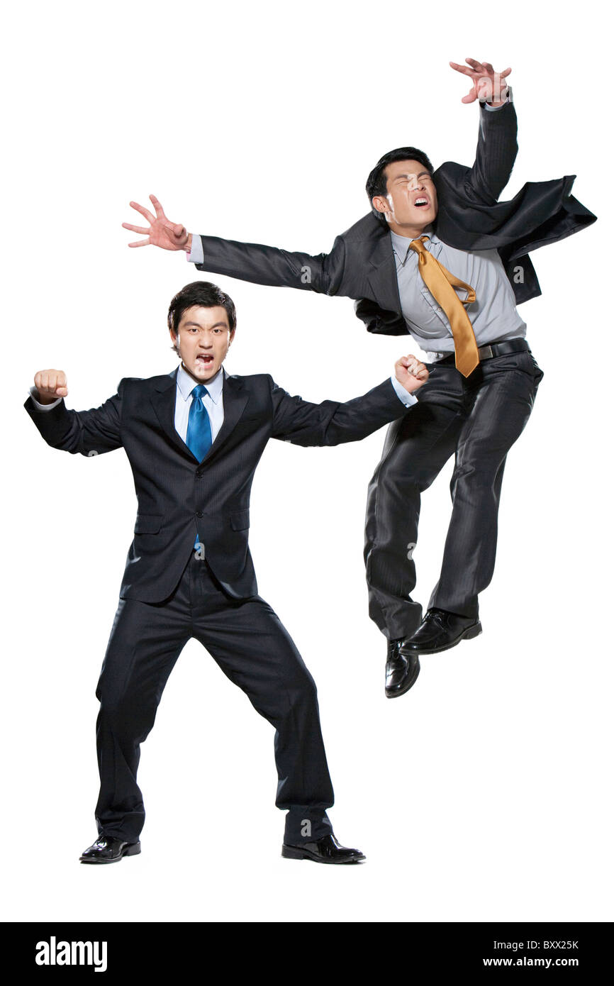 Two businessmen fighting on white background Stock Photo - Alamy