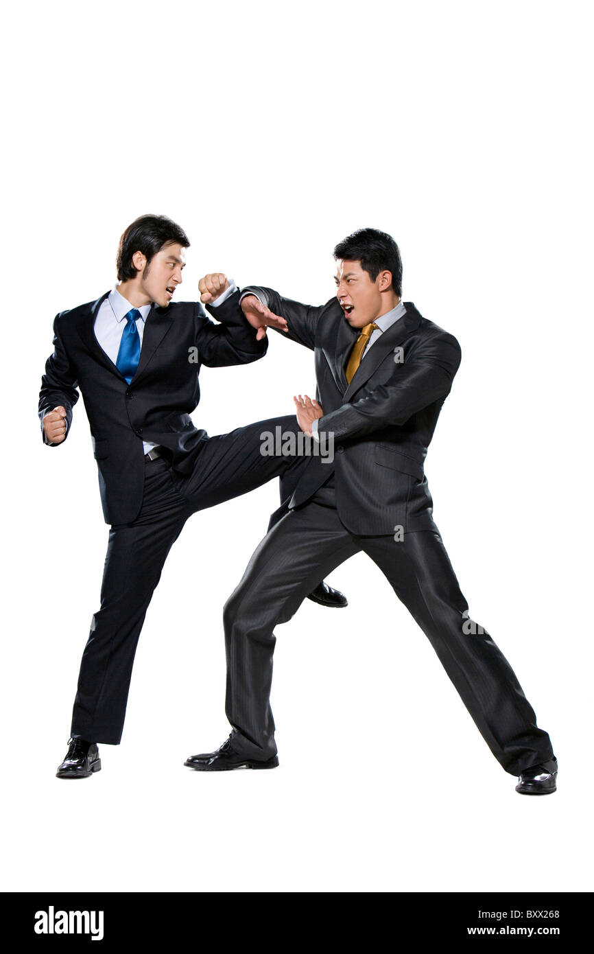 Two businessmen fighting on white background Stock Photo - Alamy