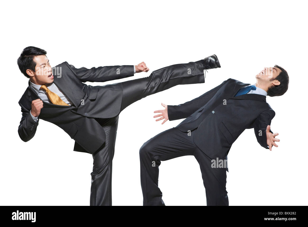 Two businessmen fighting on white background Stock Photo - Alamy