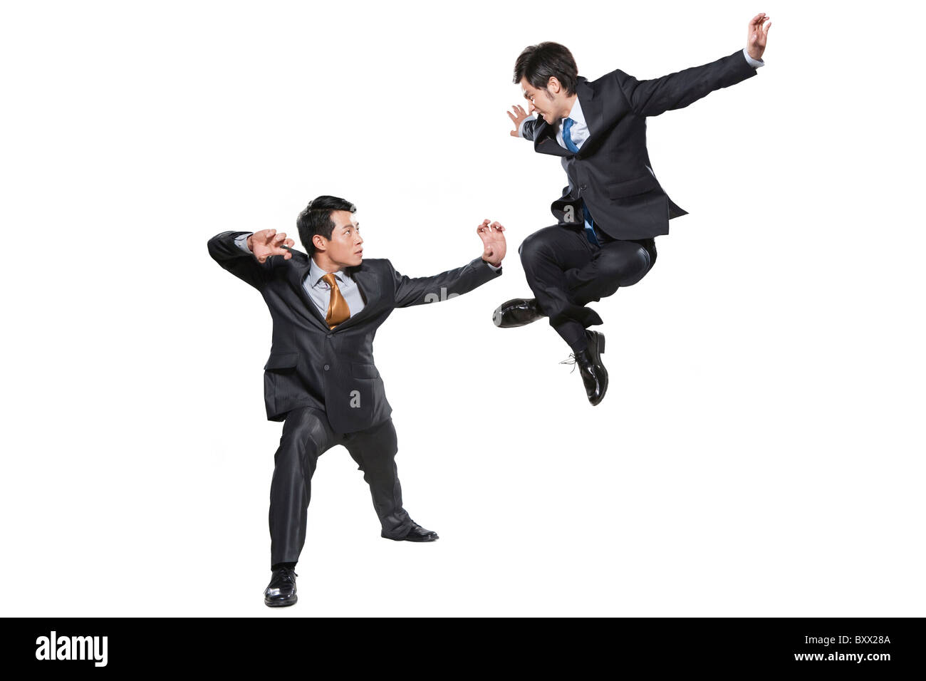 Two businessmen fighting on white background Stock Photo - Alamy
