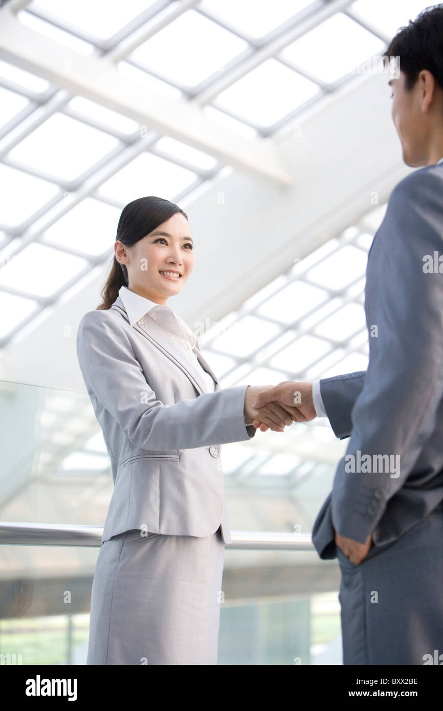 Females shaking hands on success hi-res stock photography and images ...