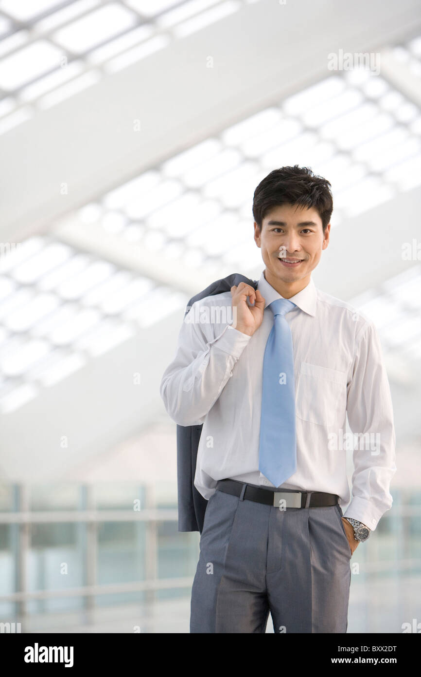 Businessman jacket over shoulder Stock Photo - Alamy