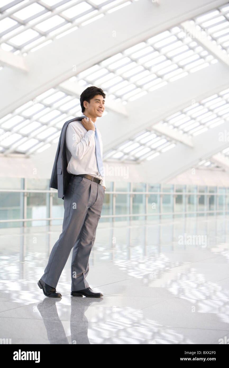 Businessman jacket over shoulder Stock Photo - Alamy