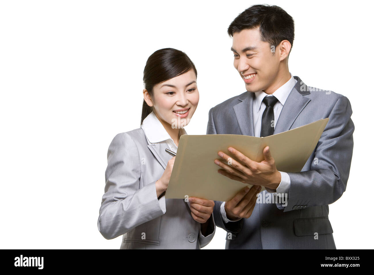 Businessmen looking through papers Stock Photo - Alamy