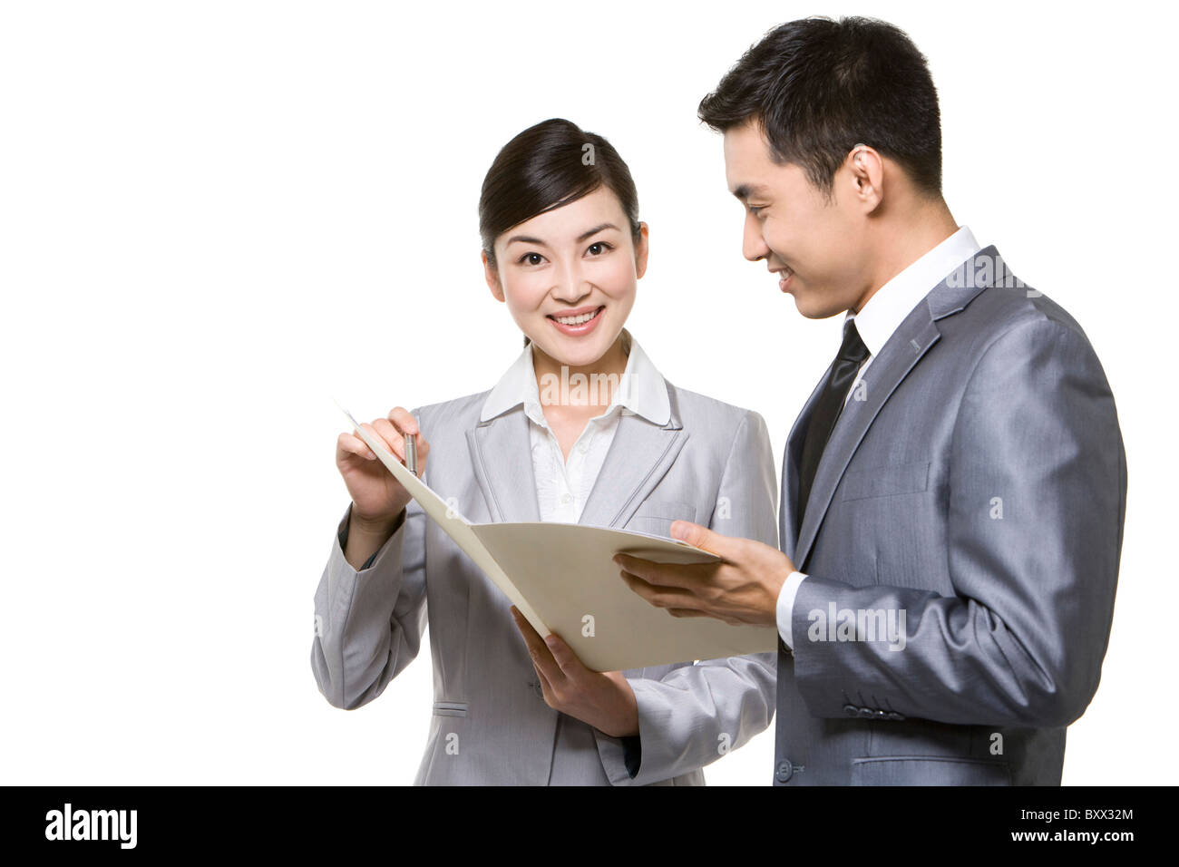 Businessmen looking through papers Stock Photo - Alamy