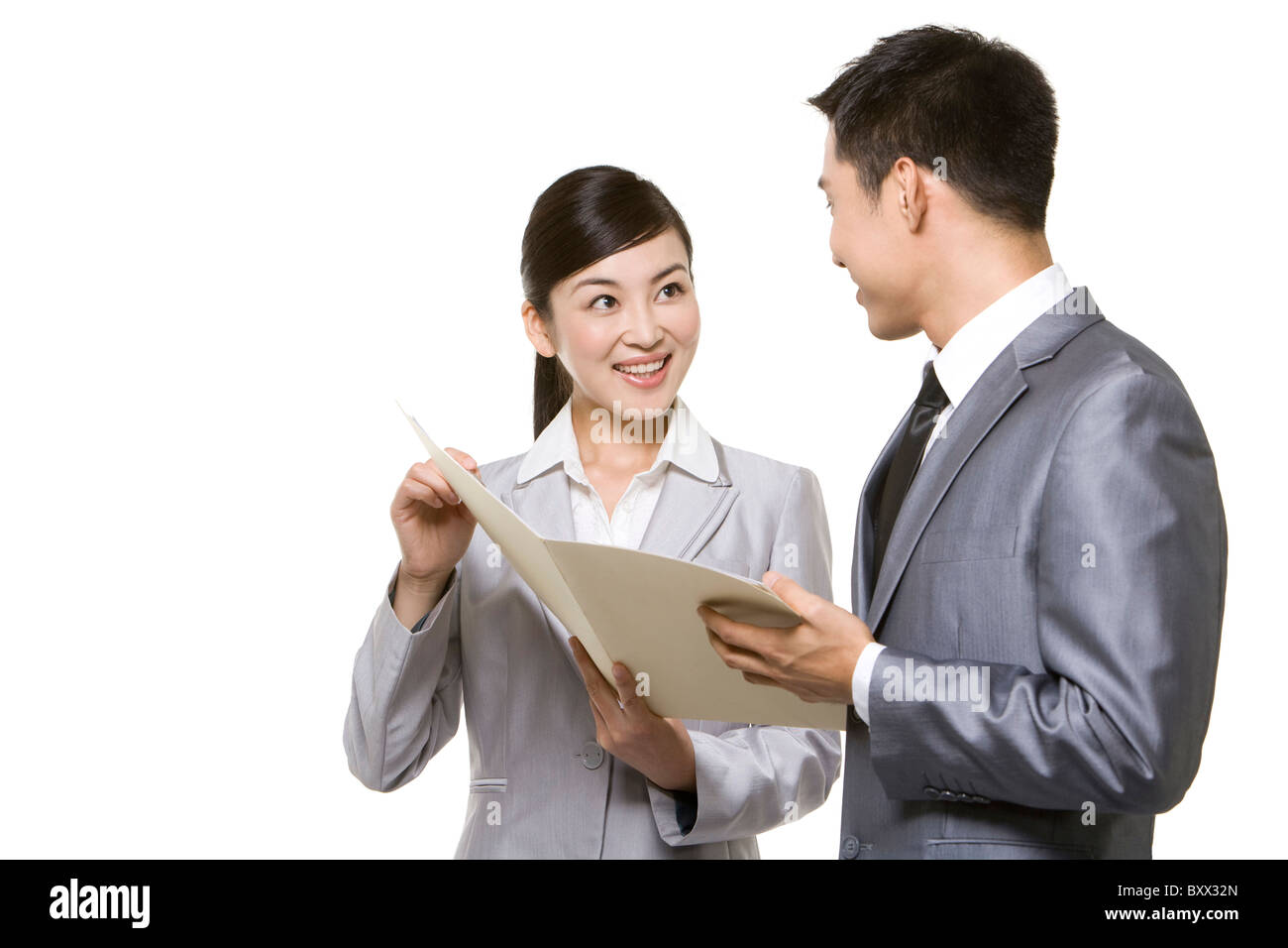 Businessmen looking through papers Stock Photo - Alamy