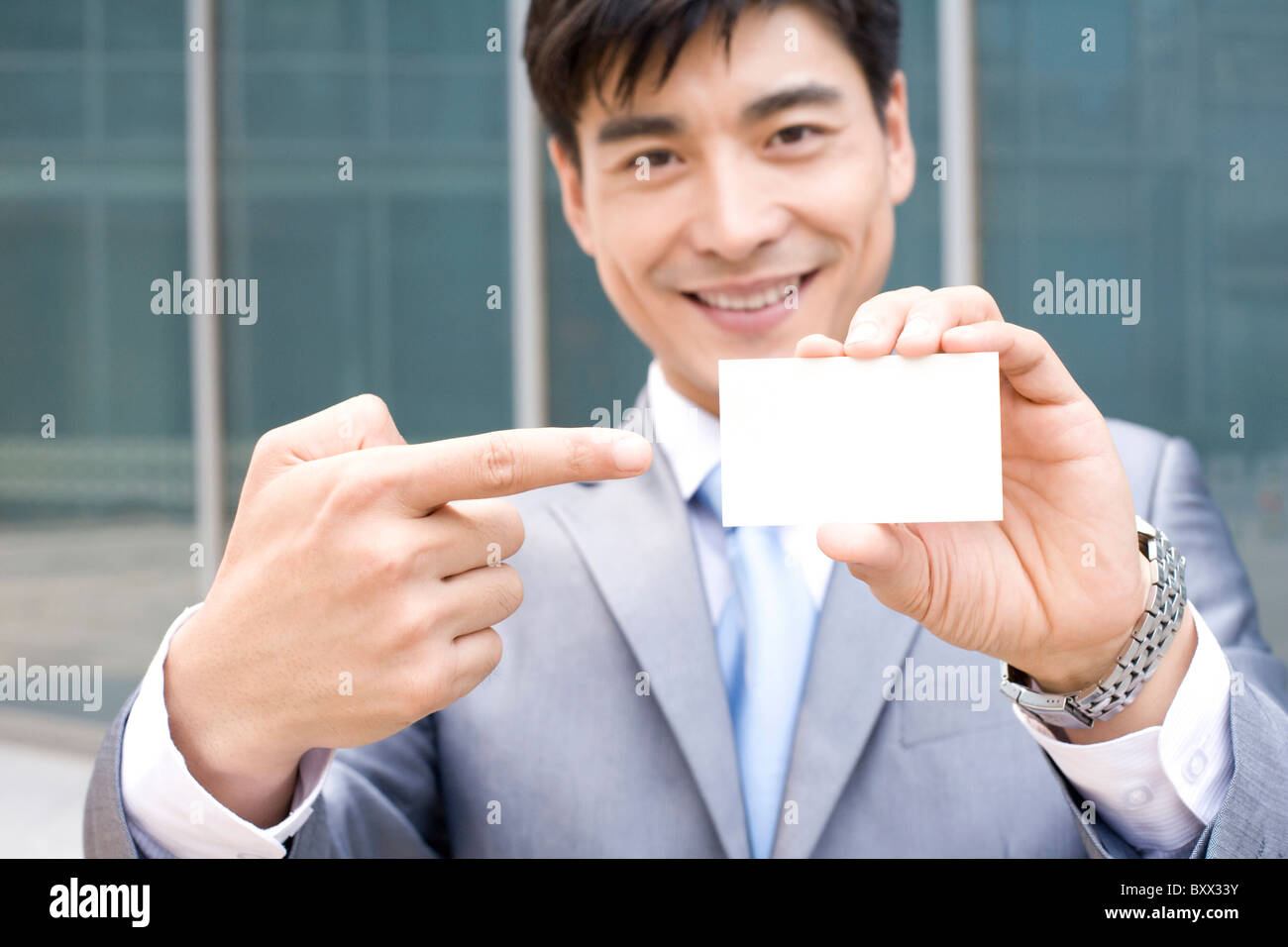 Businessman pointing a card Stock Photo - Alamy