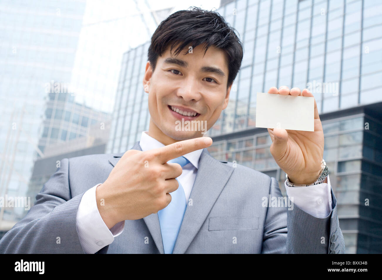 Businessman pointing a card Stock Photo - Alamy