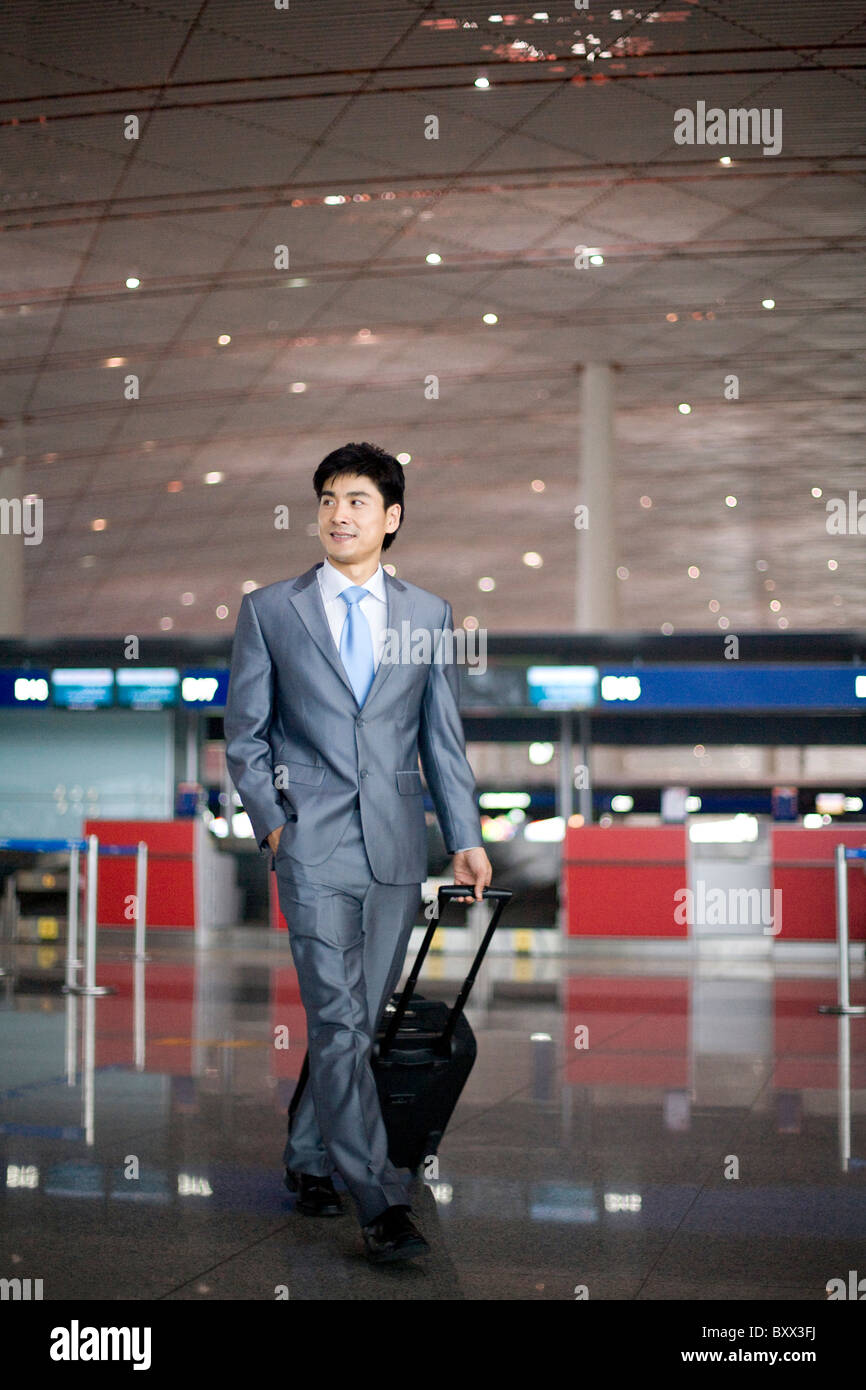 Businessman in airport Stock Photo - Alamy