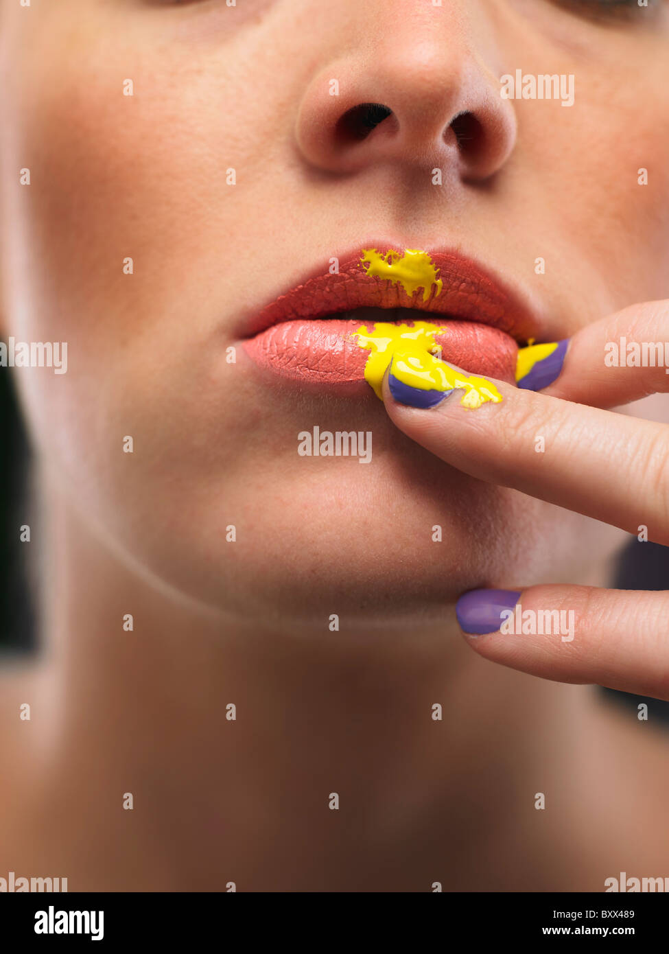 white womans hand smearing paint across her lips Stock Photo - Alamy