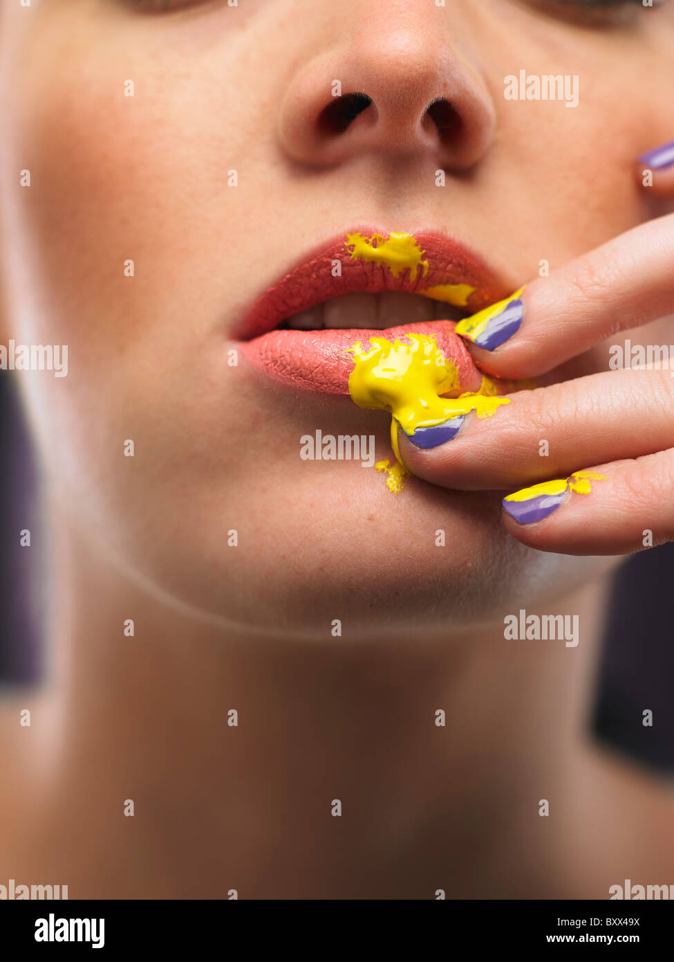 white womans hand smearing paint across her lips Stock Photo - Alamy