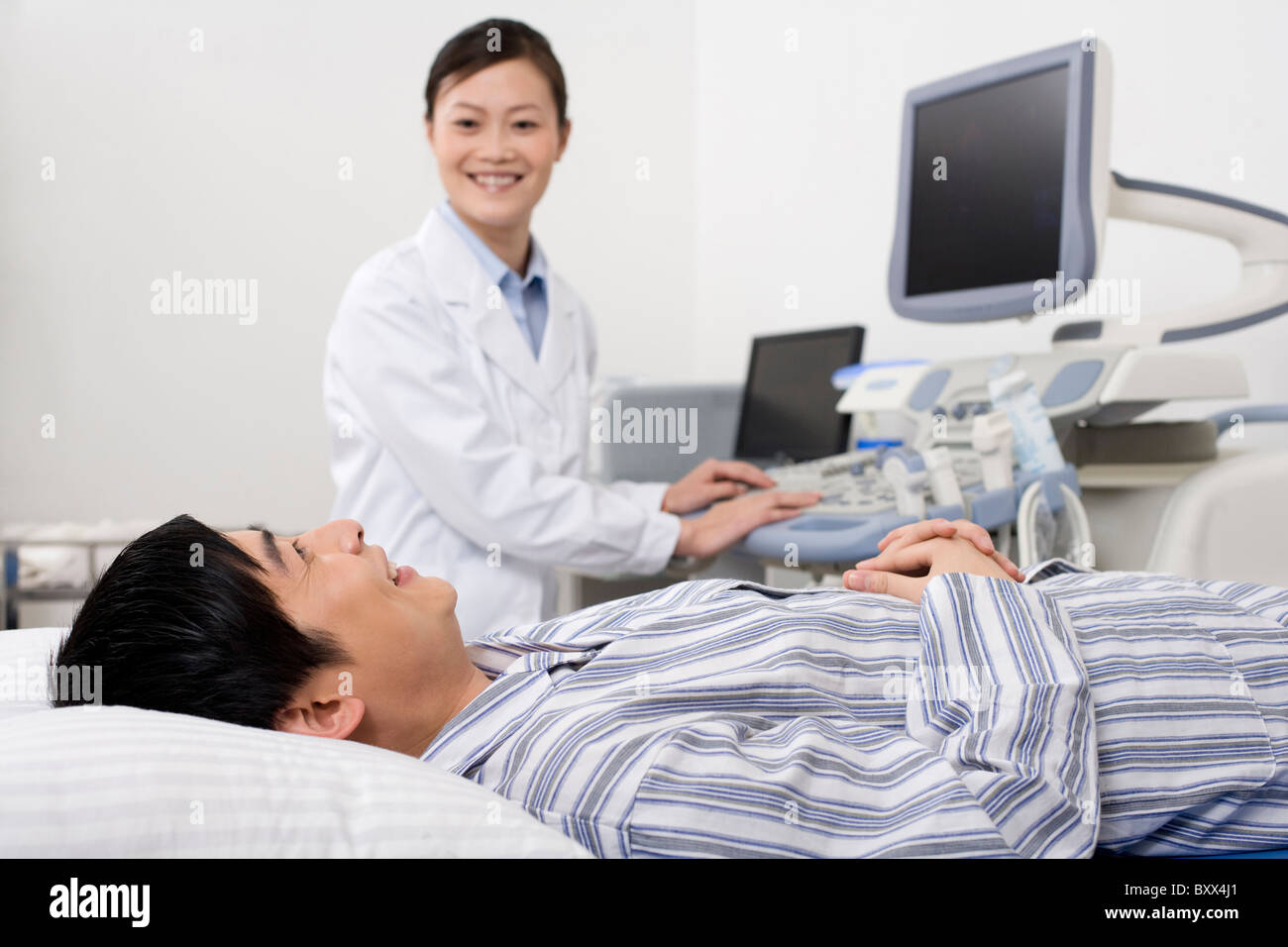 Doctor examining a patient Stock Photo - Alamy