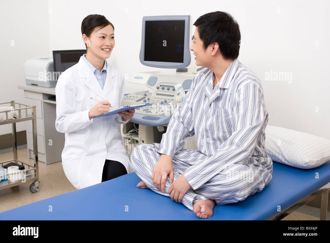 Doctor examining a patient Stock Photo - Alamy