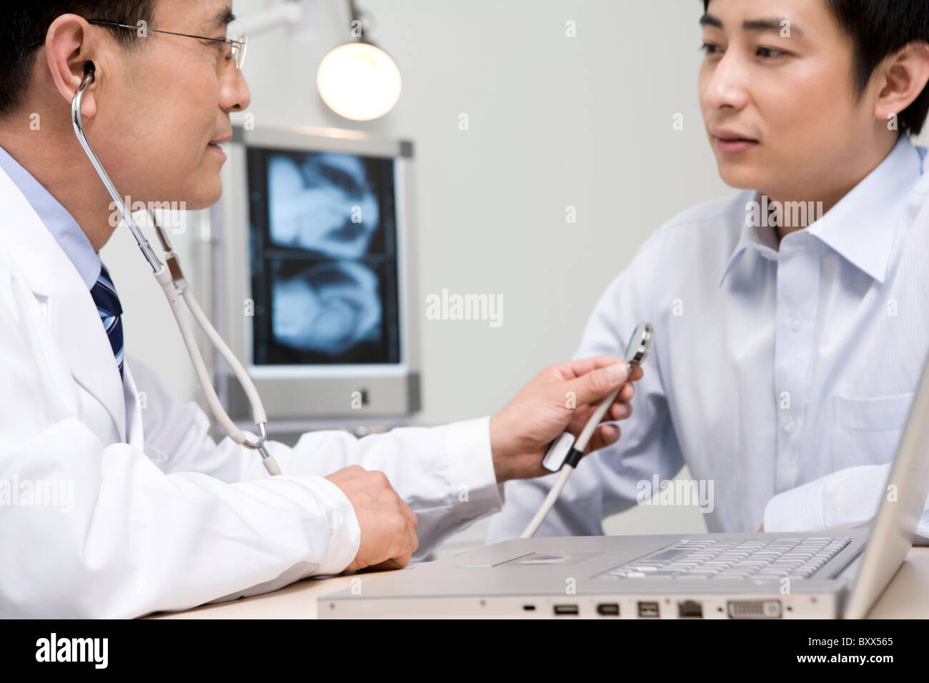 Doctor examining a patient Stock Photo - Alamy