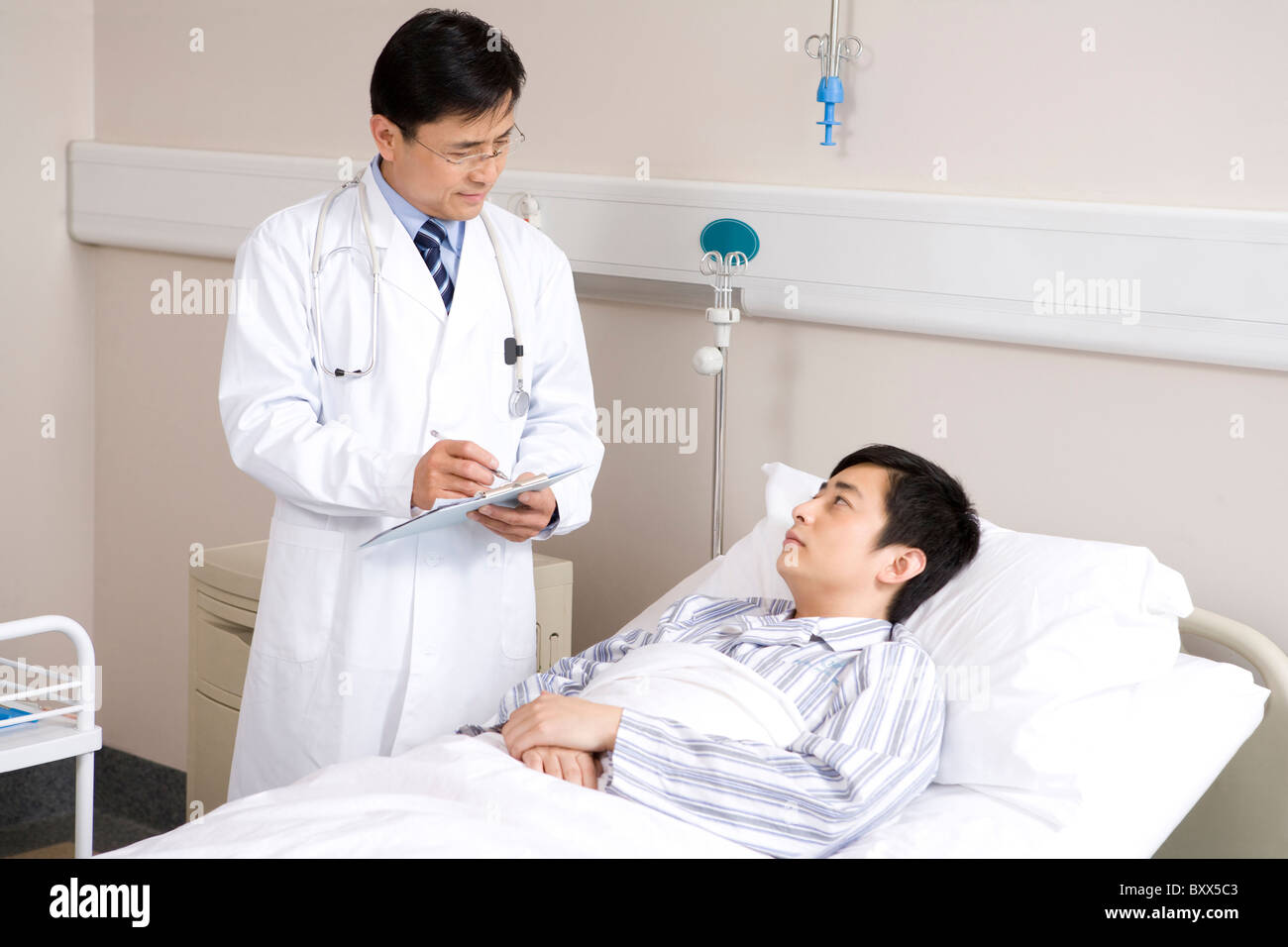 Doctor examining a patient Stock Photo - Alamy