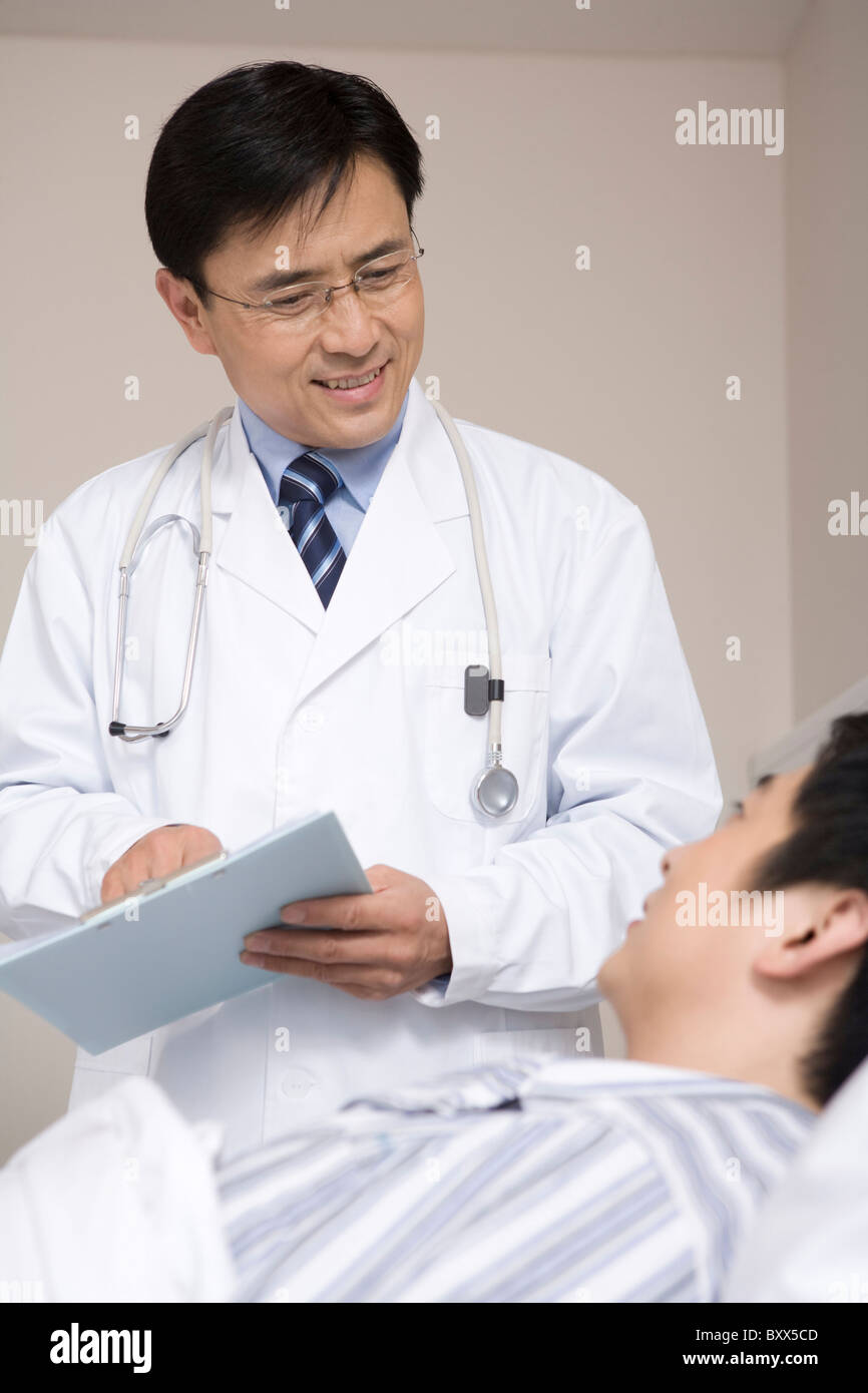 Doctor examining a patient Stock Photo - Alamy