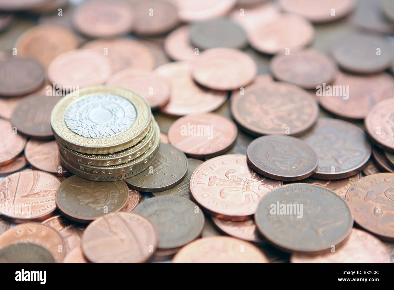 A small stack of sterling £2 coins resting on a jumble of 2p and 1p ...