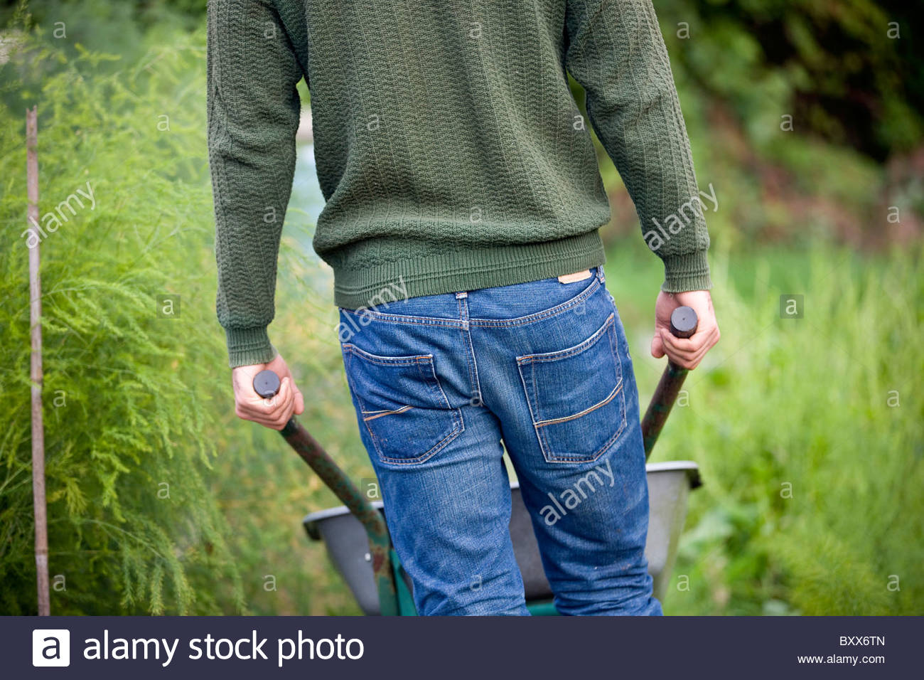 Man Pushing Wheel Barrow Stock Photos & Man Pushing Wheel Barrow Stock ...