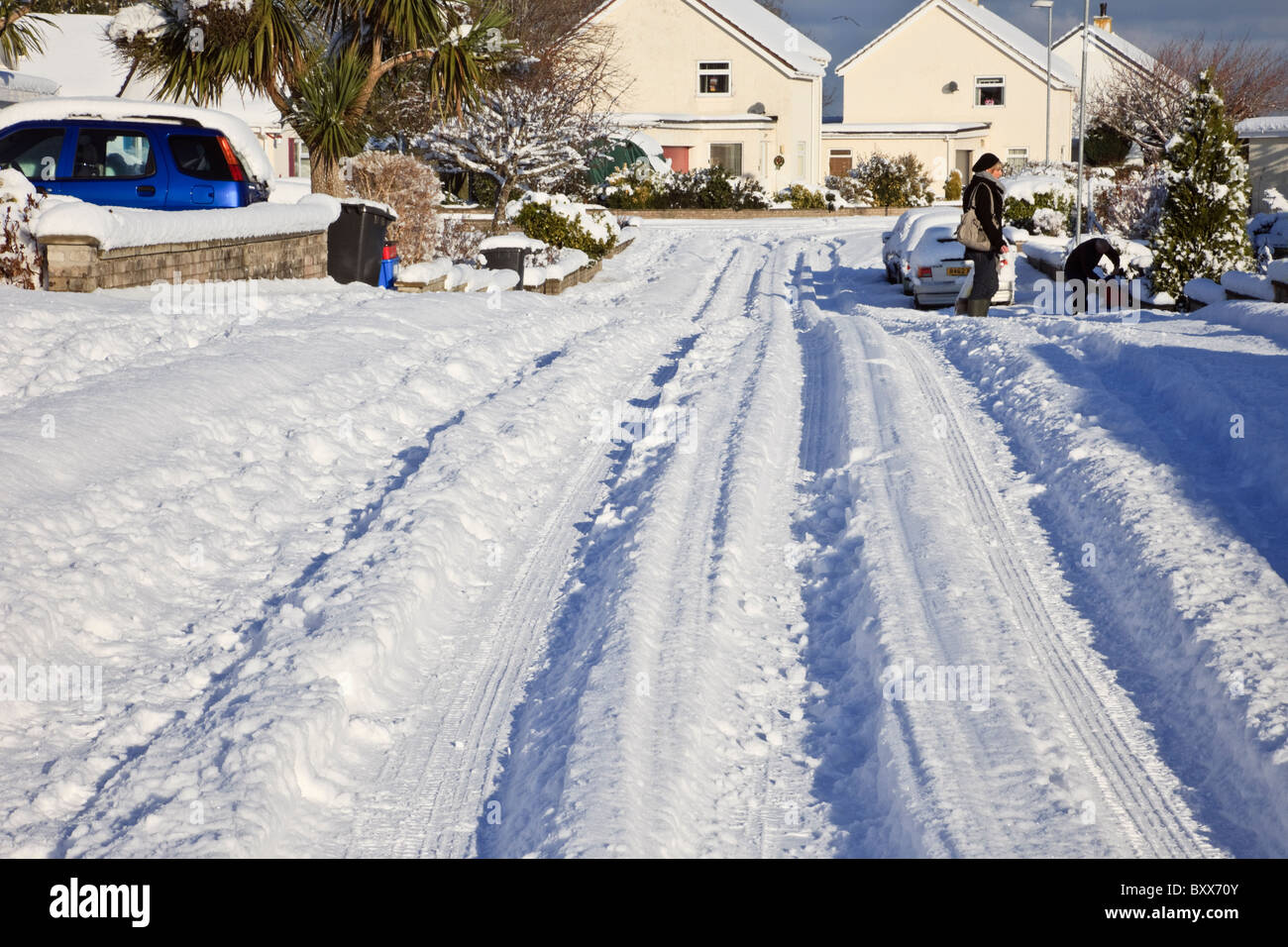 Deep ruts from tyre tracks in snow on suburban street after heavy ...