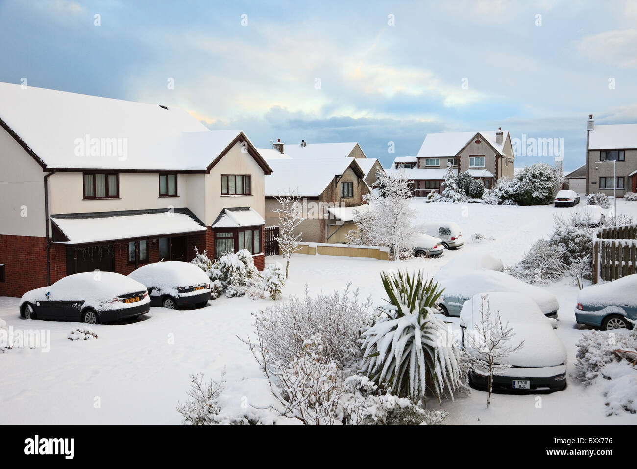Snow on suburban estate residential street and houses after heavy ...