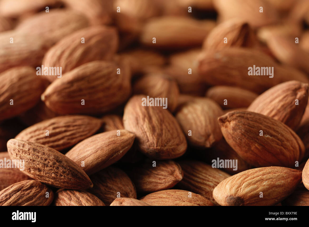 Shelled Almonds with their skins on in a pile Stock Photo - Alamy